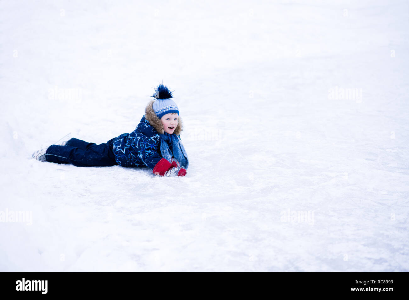 active winter holiday - cute little boy skating on an ice rink Stock ...