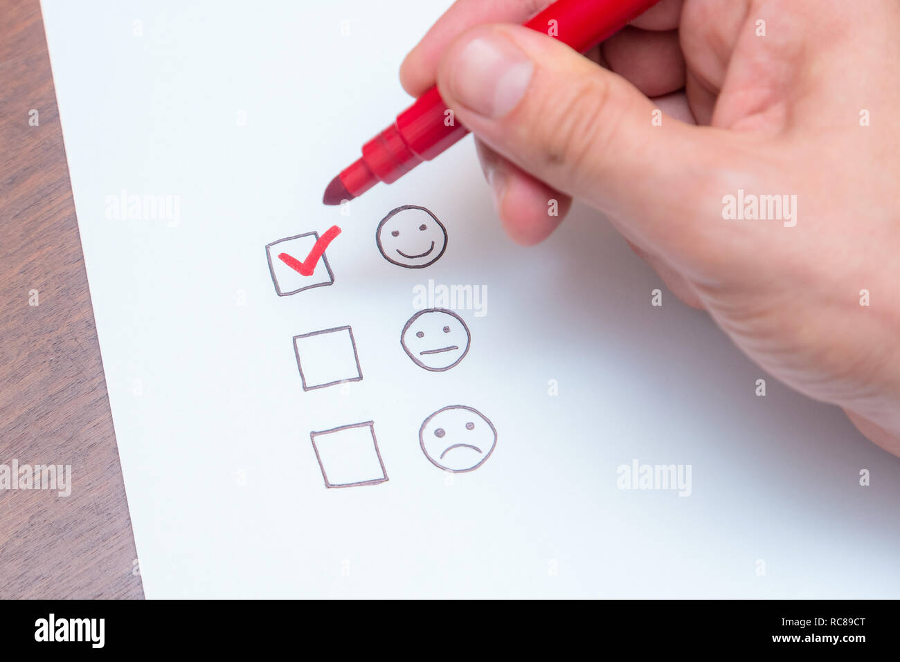 Human hand, tick placed on excellent check box. Customer service ...