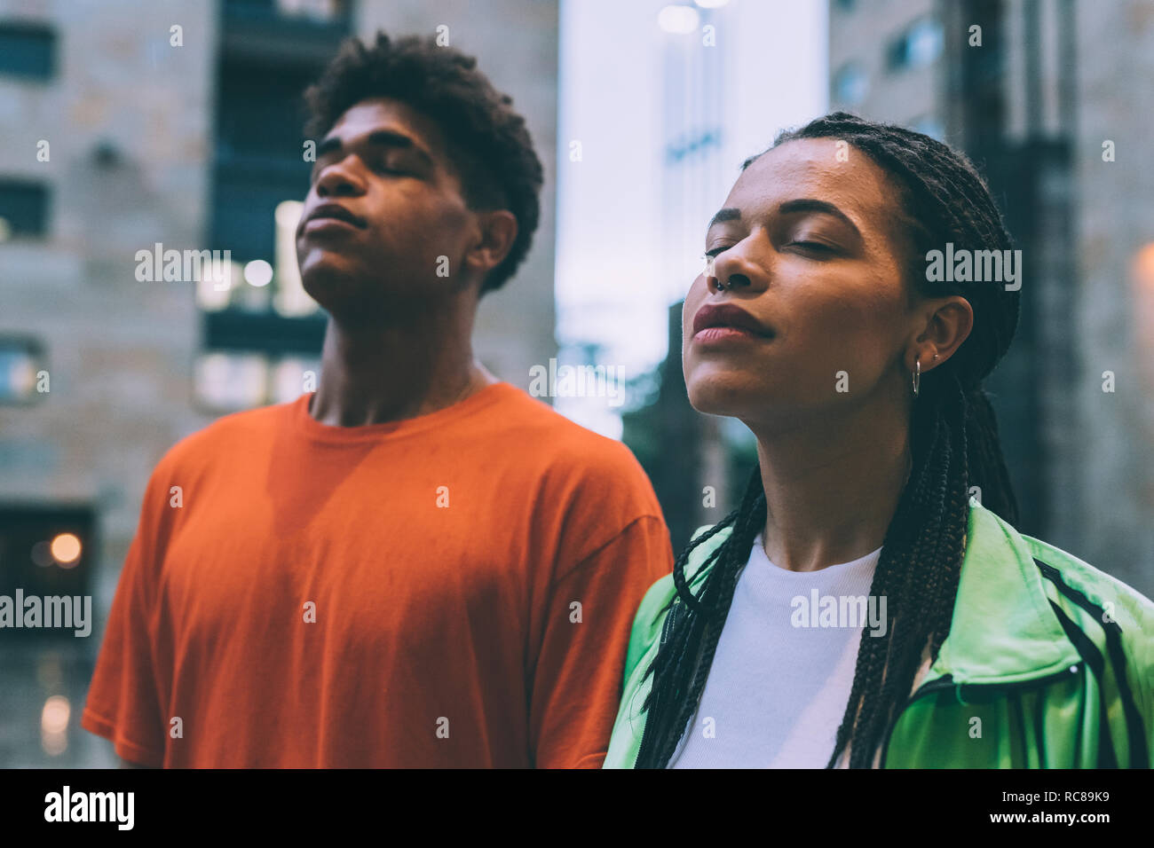 Brother and sister side by side with eyes closed, Milan, Italy Stock ...