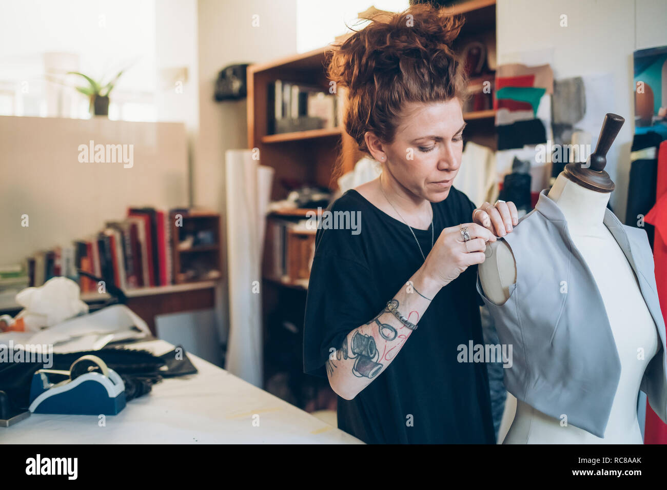 Fashion designer pinning garment onto dressmaker's dummy Stock Photo ...