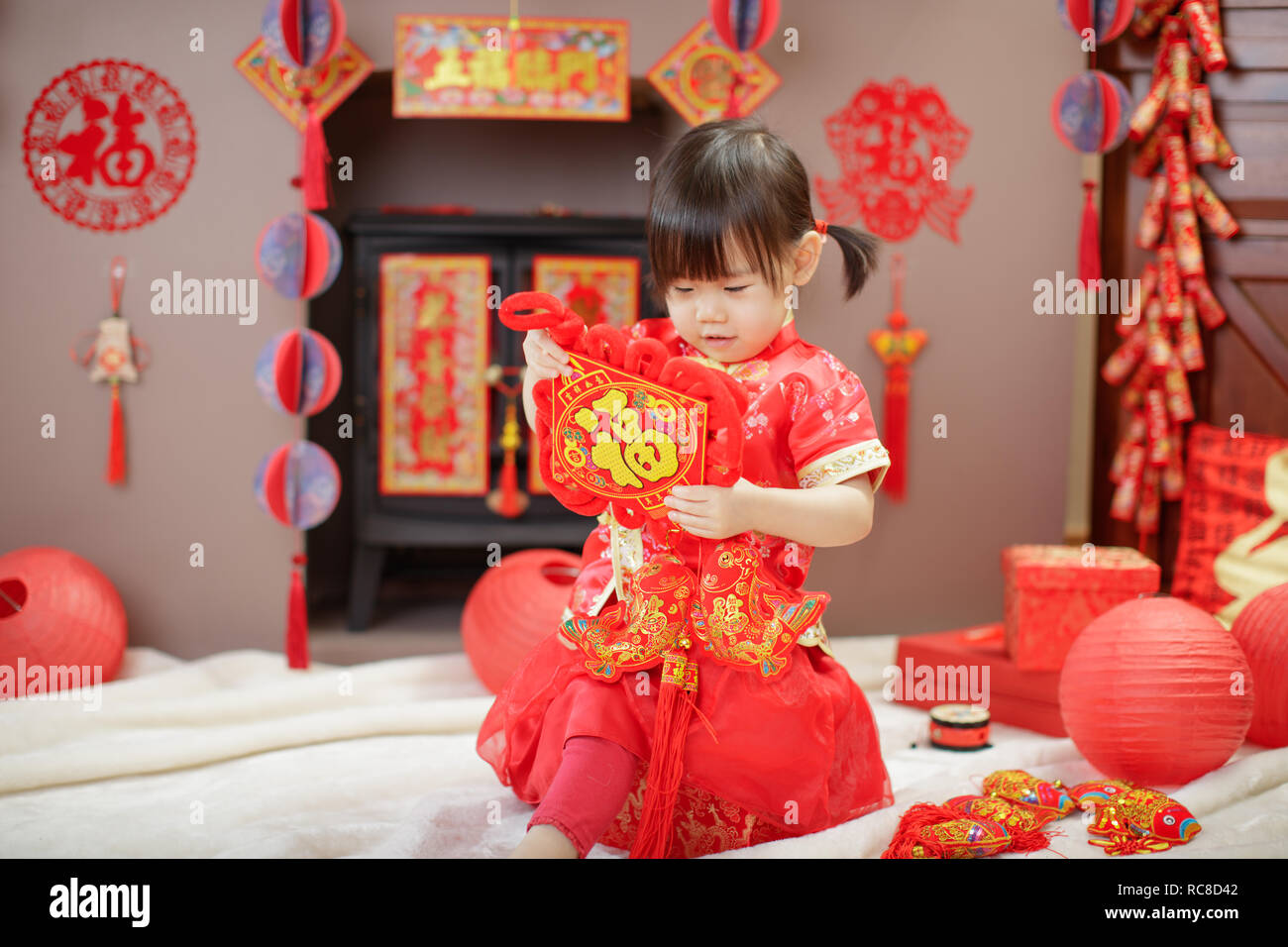Chinese baby girl traditional dressing up hold a Fu means 'lucky ...