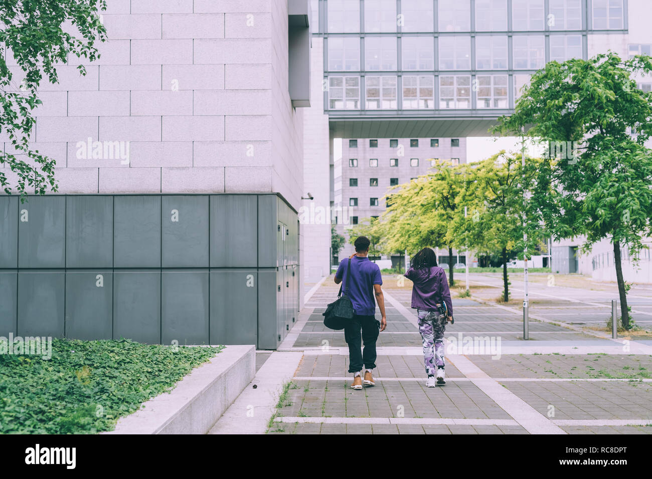 Friends walking in building complex hi-res stock photography and images ...