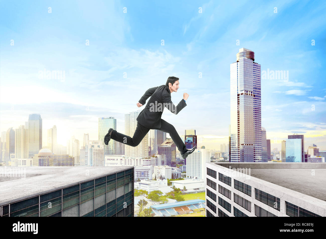 Successful business man jumping over hi-res stock photography and ...