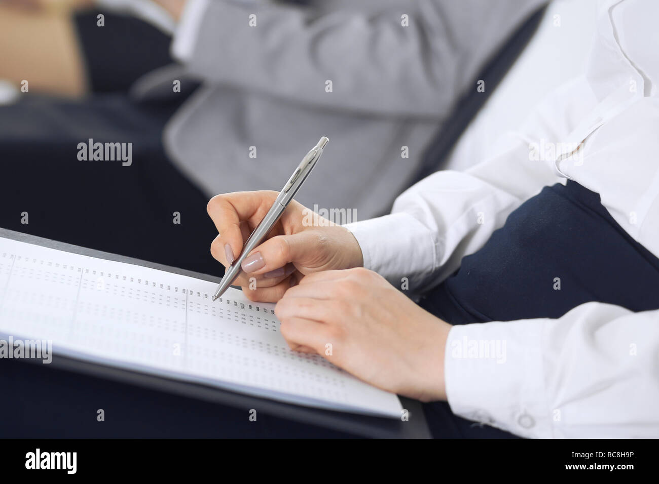 Business people taking part at conference or training at office, close ...