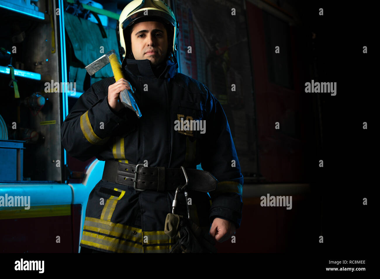 Photo of man firefighter with pick near fire truck Stock Photo - Alamy