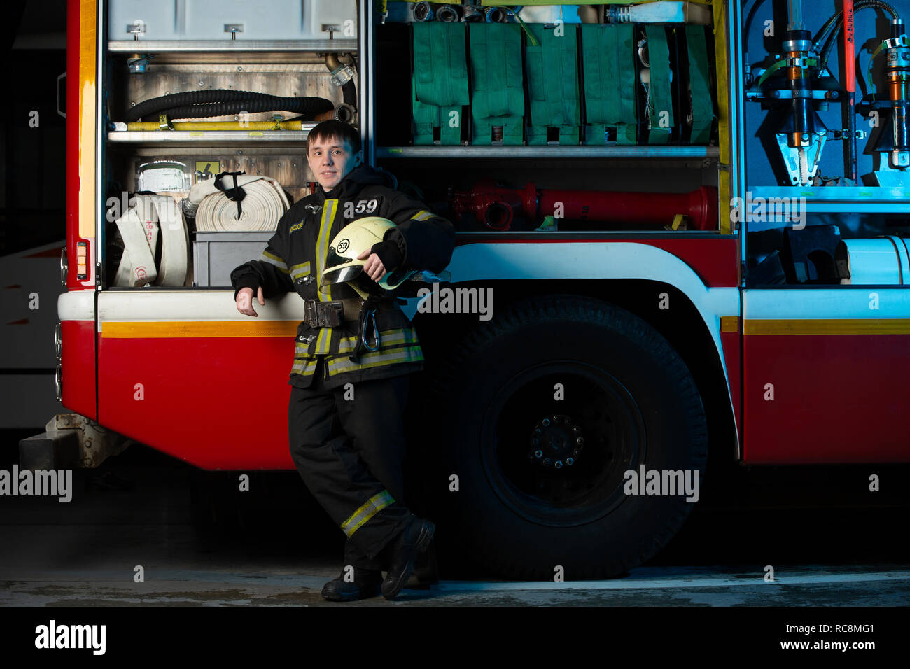 Photo of fireman man near fire truck Stock Photo - Alamy