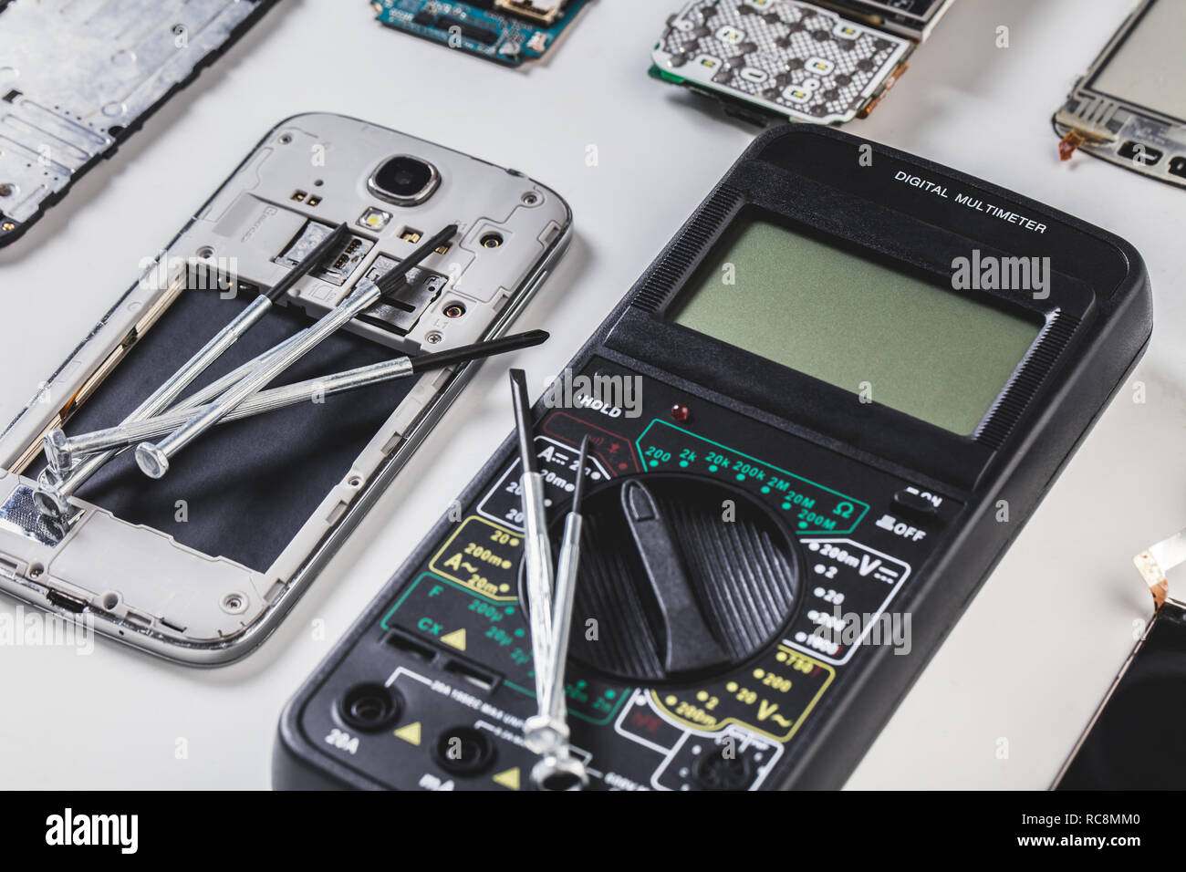 disassembled mobile phone and tools on white background Stock Photo - Alamy