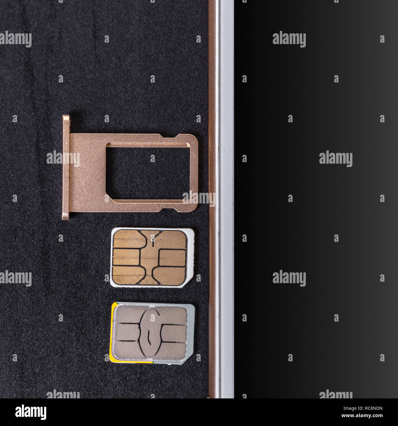 mobile phone and sim card on a black background Stock Photo - Alamy