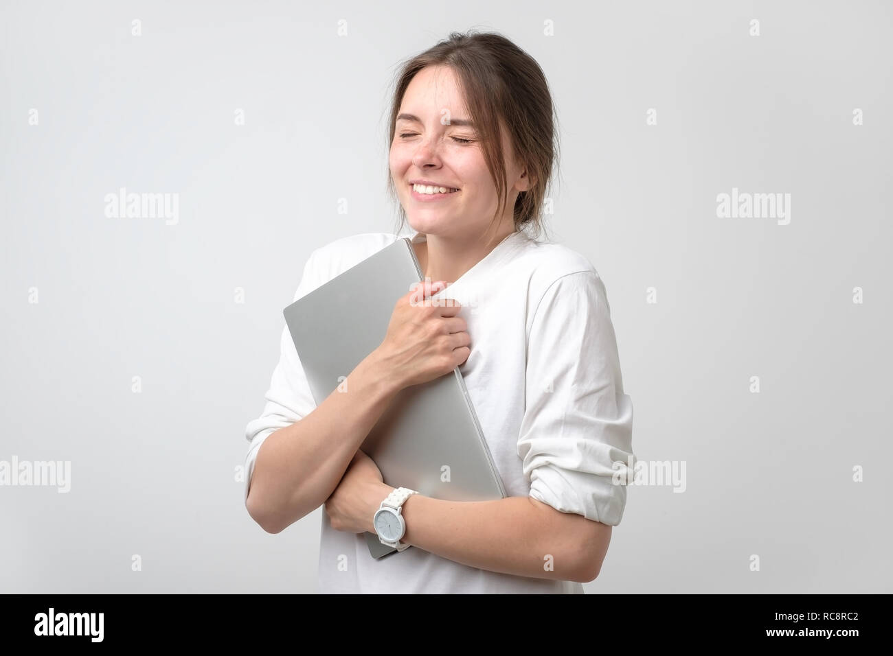 Hugging laptop hi-res stock photography and images - Alamy