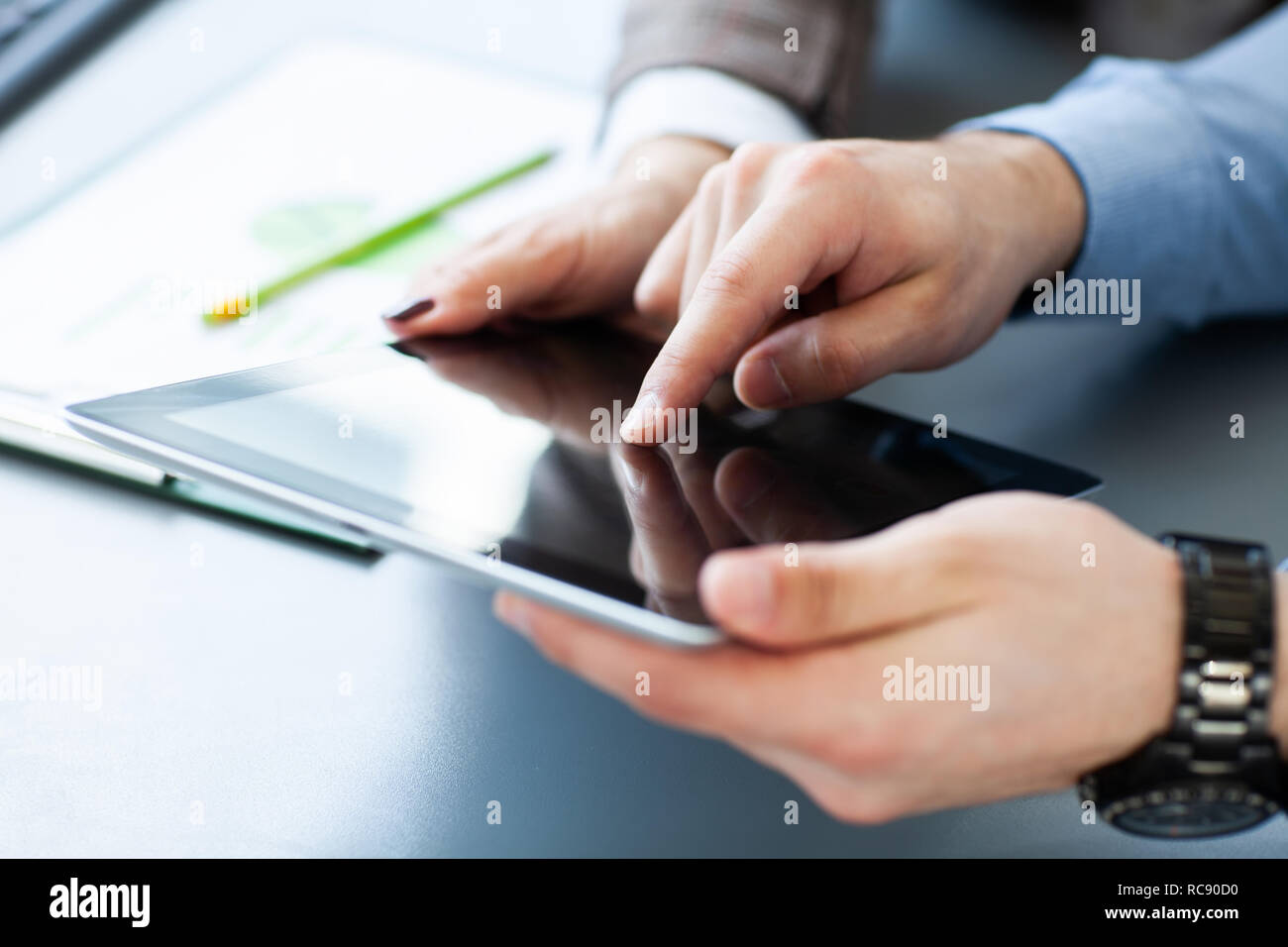 Hands holding tablet financial data hi-res stock photography and images ...