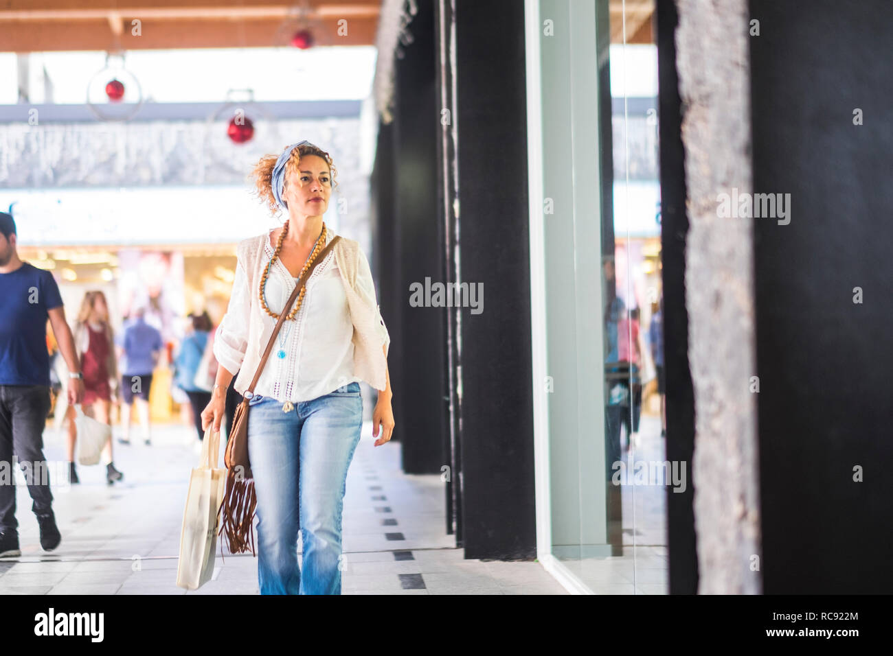 Beautiful 40 years old caucasian lady walking in commercial center mall ...