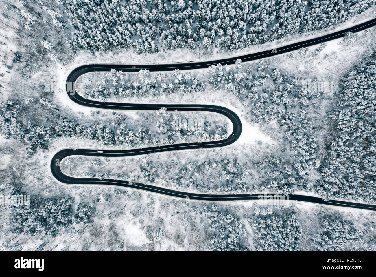 Curvy road snowy forest hi-res stock photography and images - Alamy