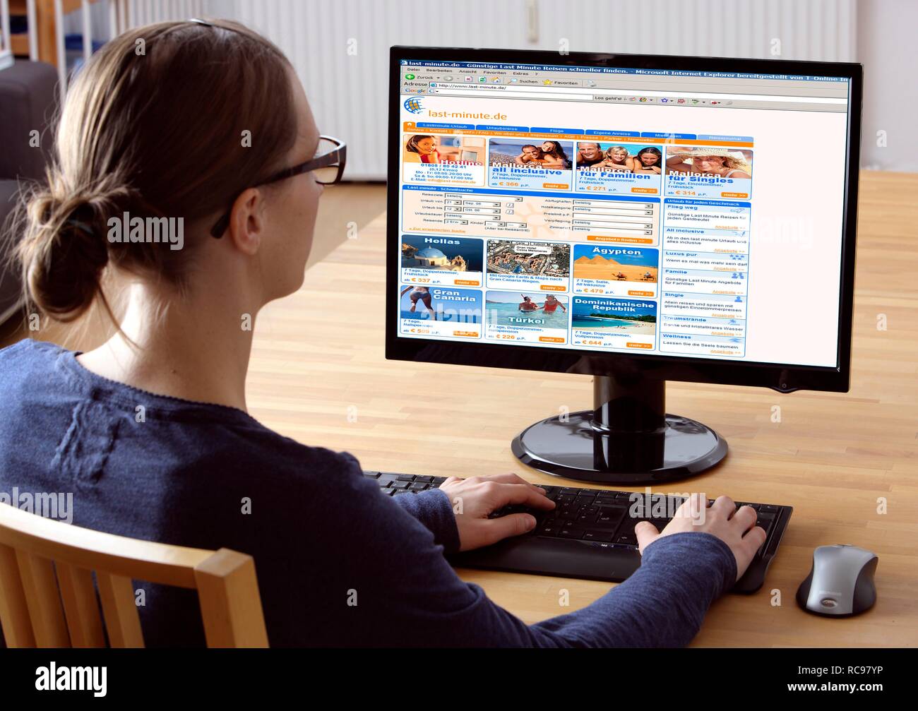 Woman surfing the internet with a computer, lastminute.de, online ...