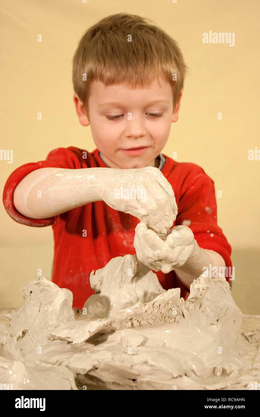 Boy doing art therapy with clay Stock Photo - Alamy