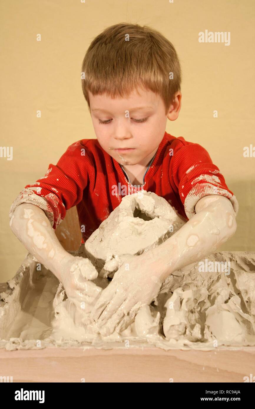 Boy doing art therapy with clay Stock Photo - Alamy