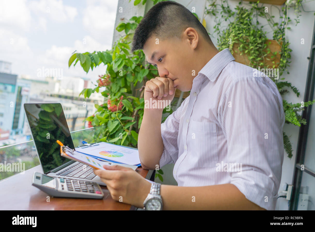 Business manager reading sales reports Stock Photo - Alamy