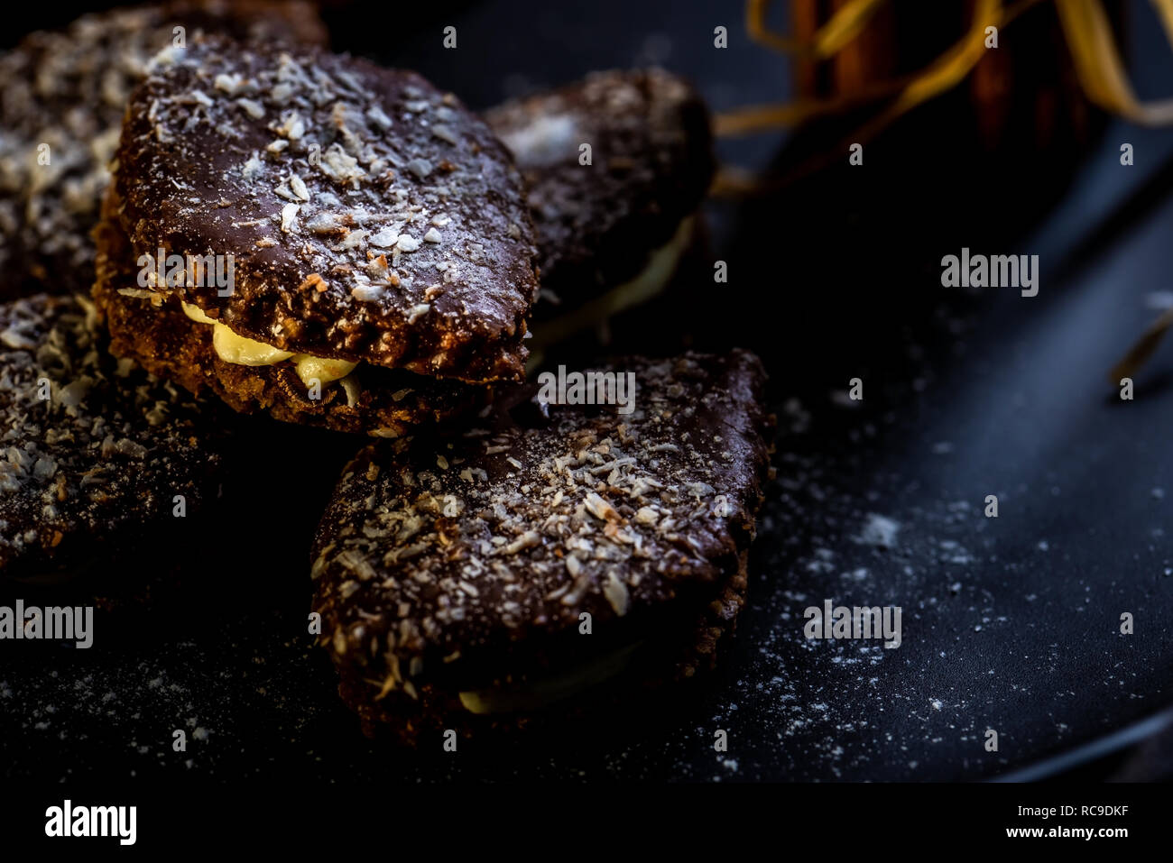 Horizontal photo of several brown sweets. Sweets are stuffed by cream ...