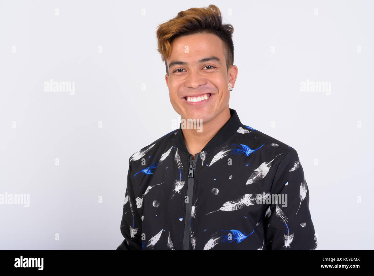 Face of happy young Asian man smiling against white background Stock ...