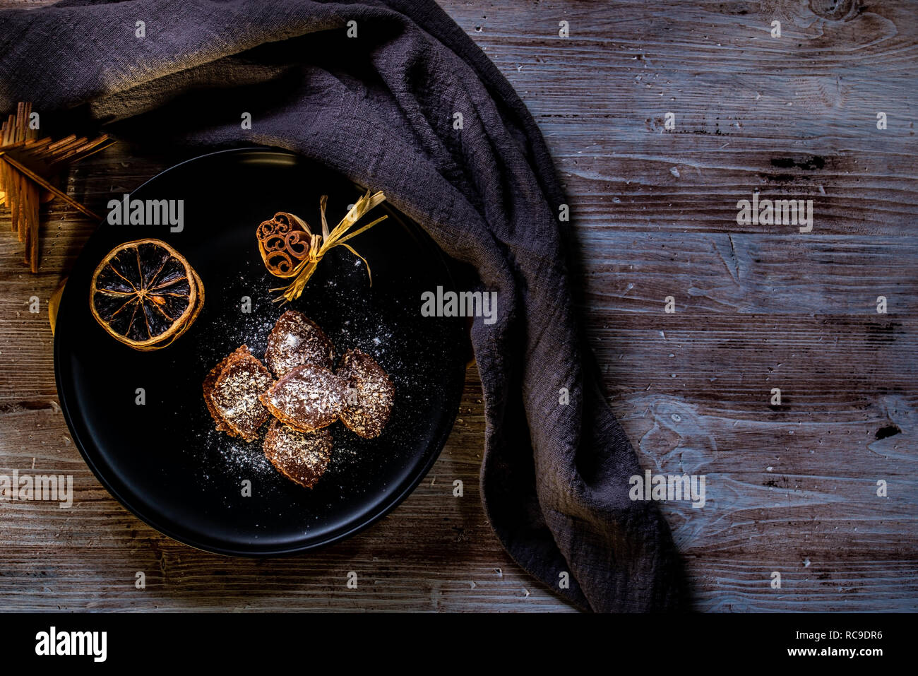 Horizontal photo of several brown sweets. Sweets are stuffed by cream ...