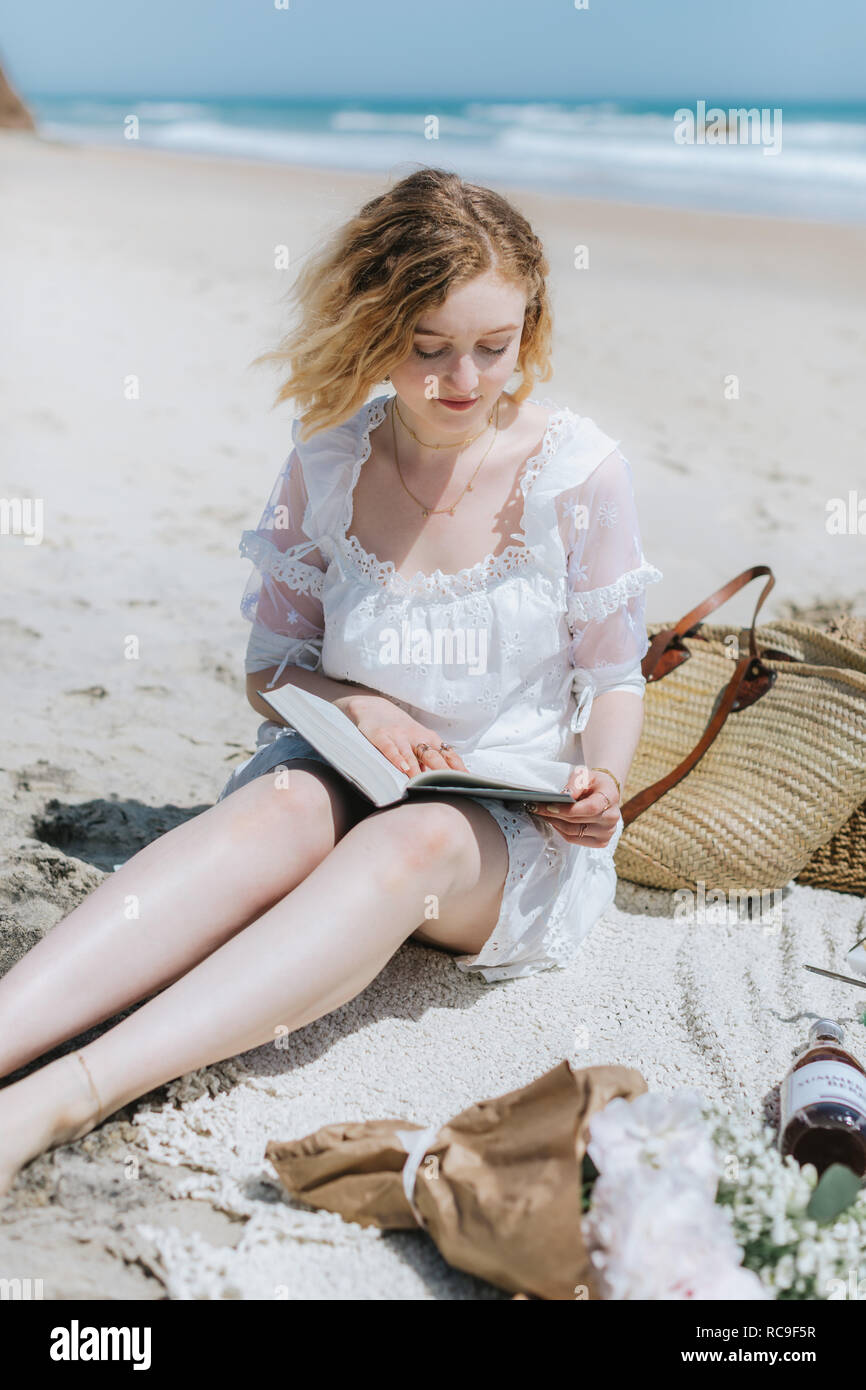 Woman alone reading beach hi-res stock photography and images - Alamy