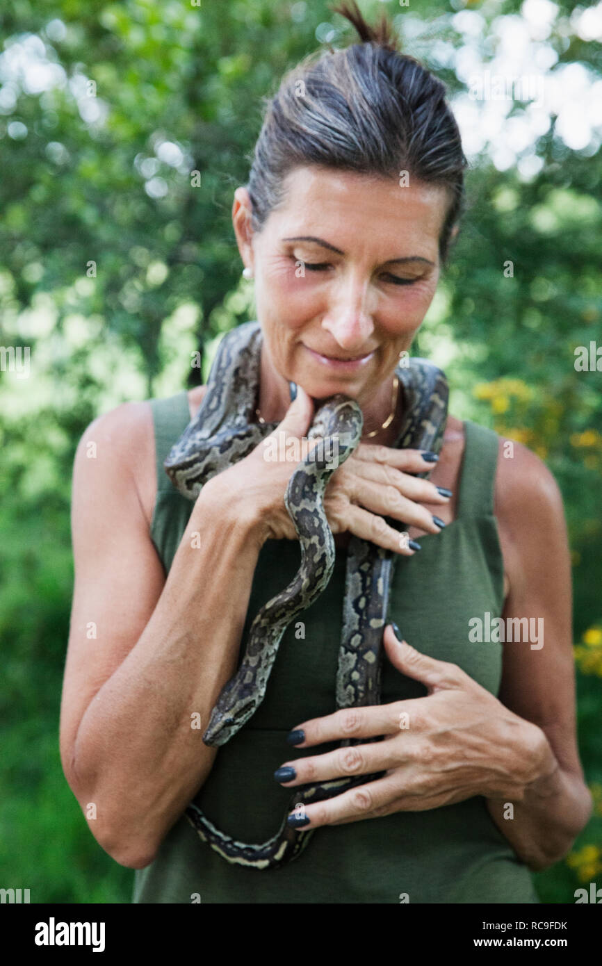 Woman holding snake hi-res stock photography and images - Alamy