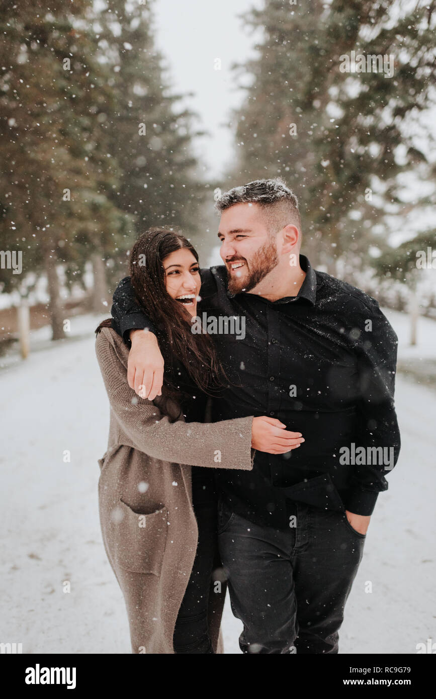Couple arm shoulder walking hi-res stock photography and images - Alamy
