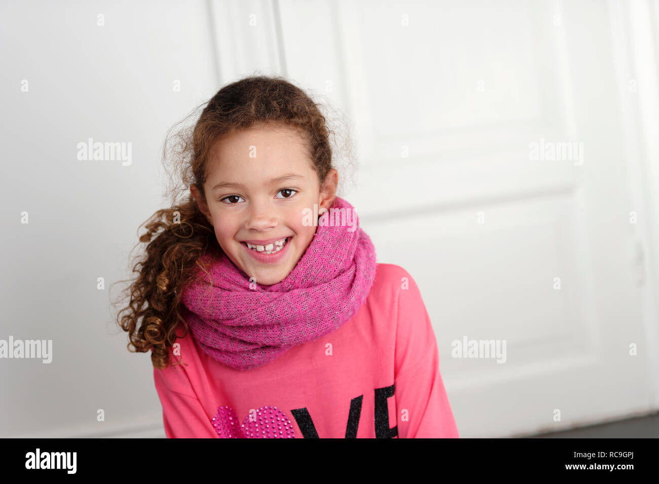 Girl pink head scarf hi-res stock photography and images - Alamy