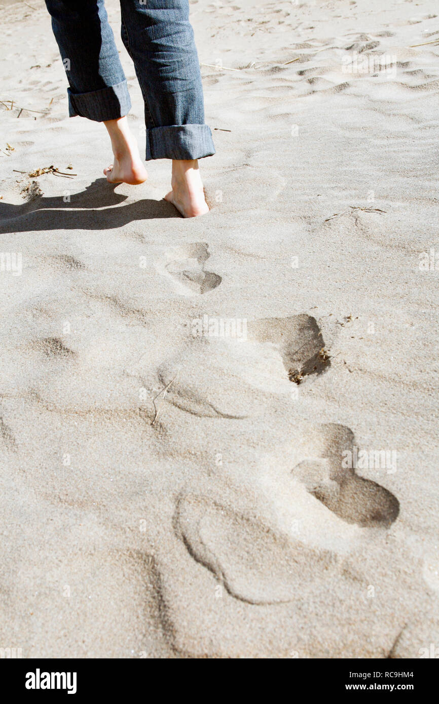 Woman walking barefoot Stock Photo - Alamy