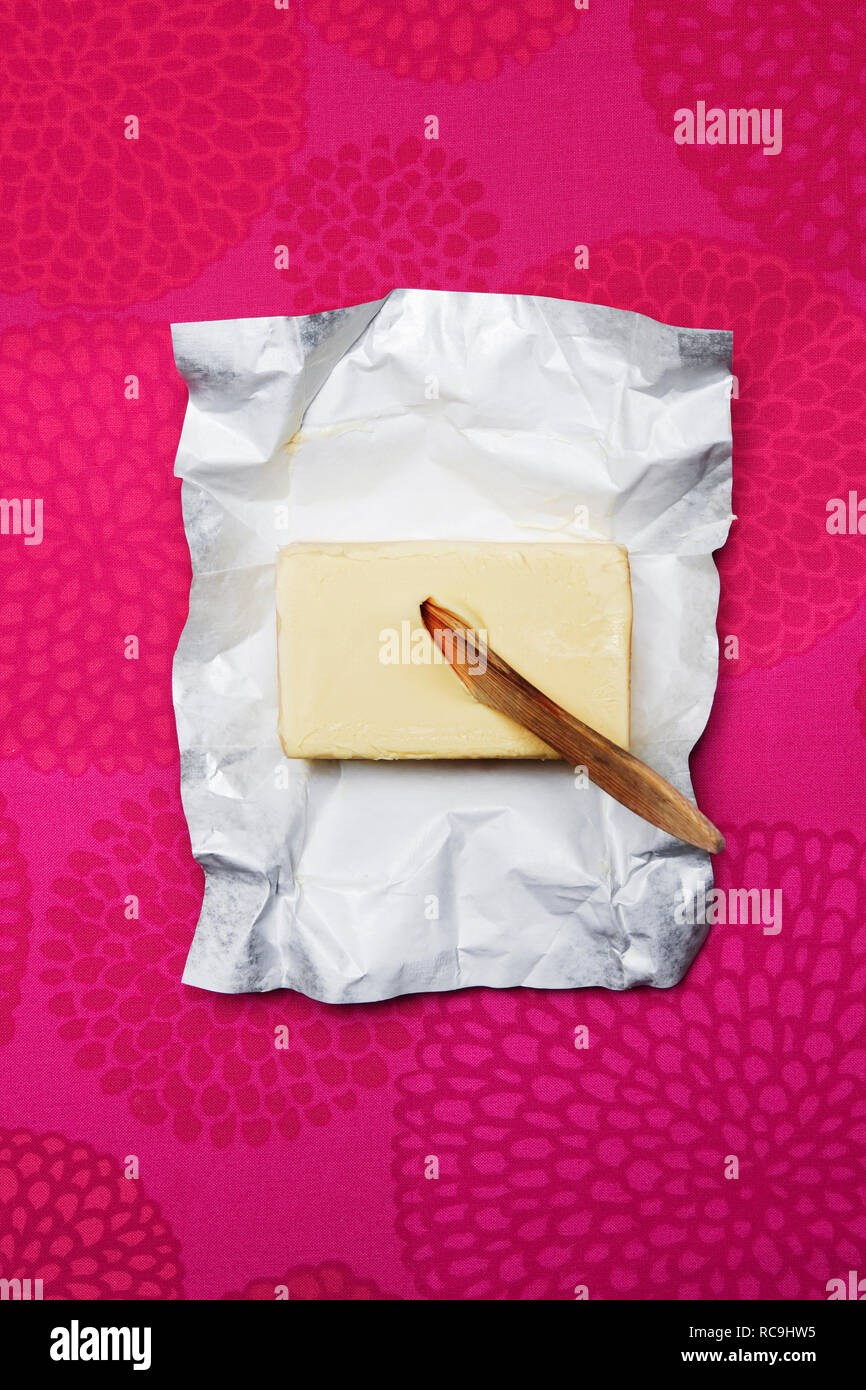 Butter on red background Stock Photo - Alamy
