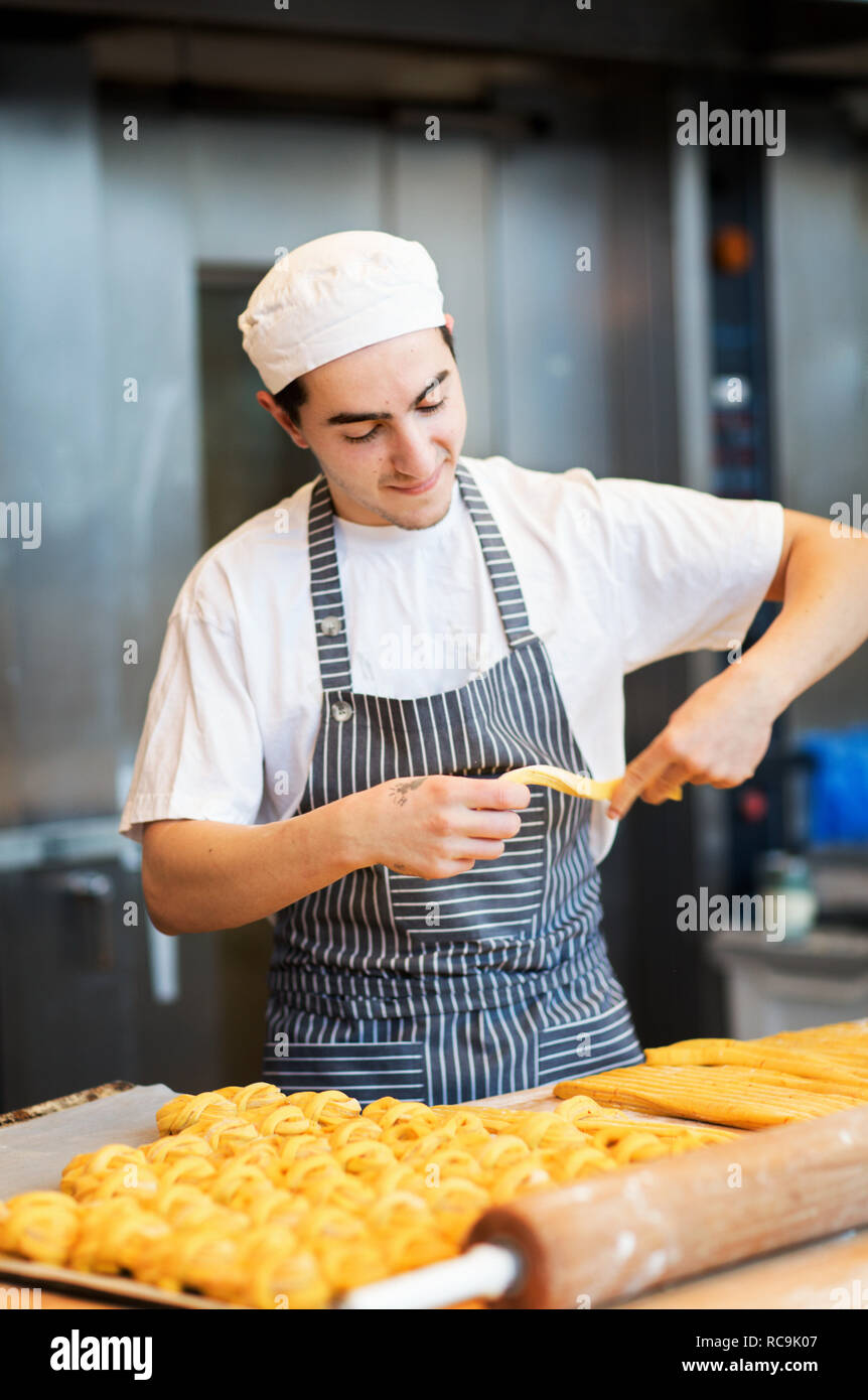 Baker working in bakery Stock Photo - Alamy