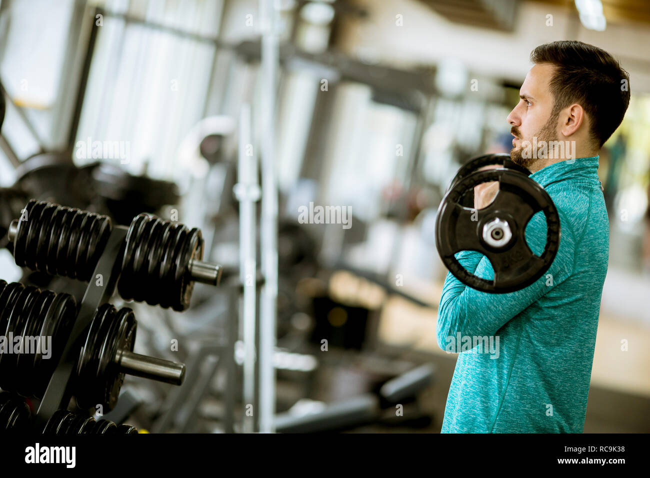 Muscular man uses dumbbells exercise hi-res stock photography and ...