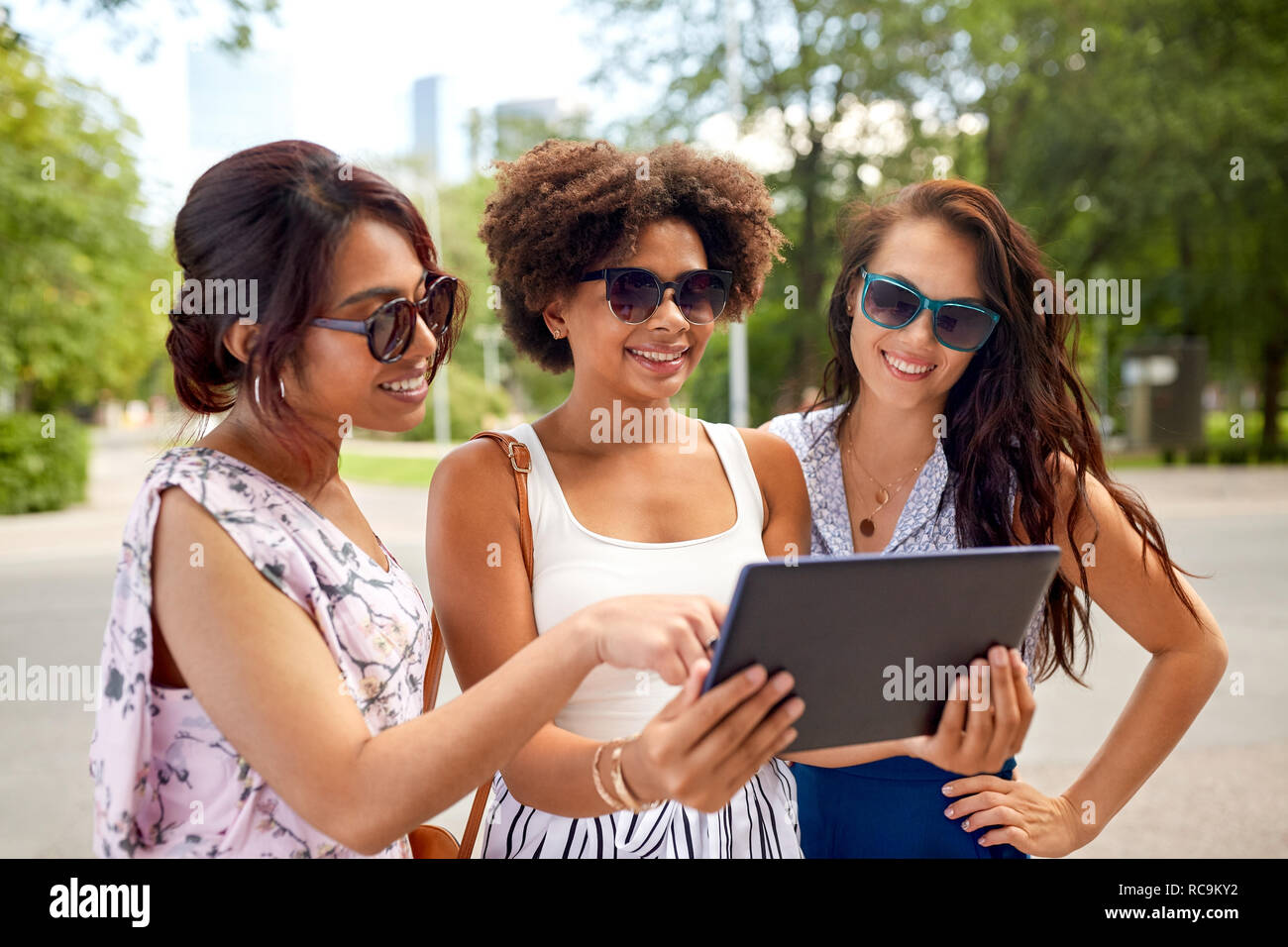 women with tablet pc on street in summer Stock Photo - Alamy