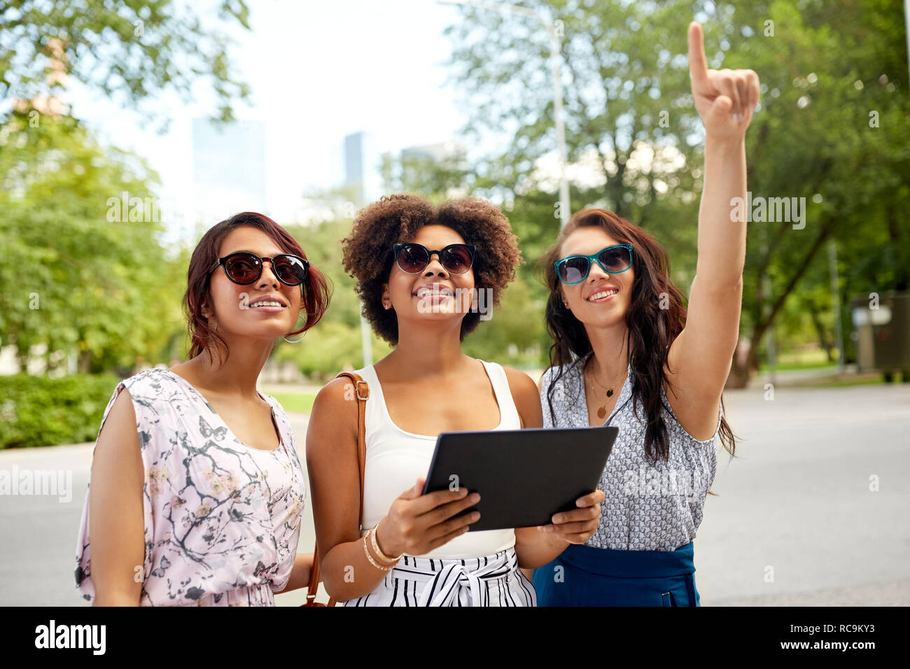 women with tablet pc on street in summer Stock Photo - Alamy