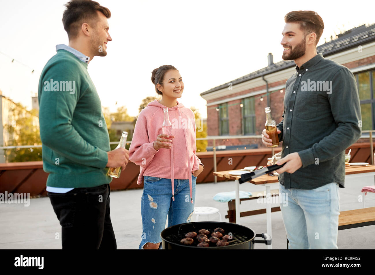 happy friends having bbq party on rooftop Stock Photo - Alamy