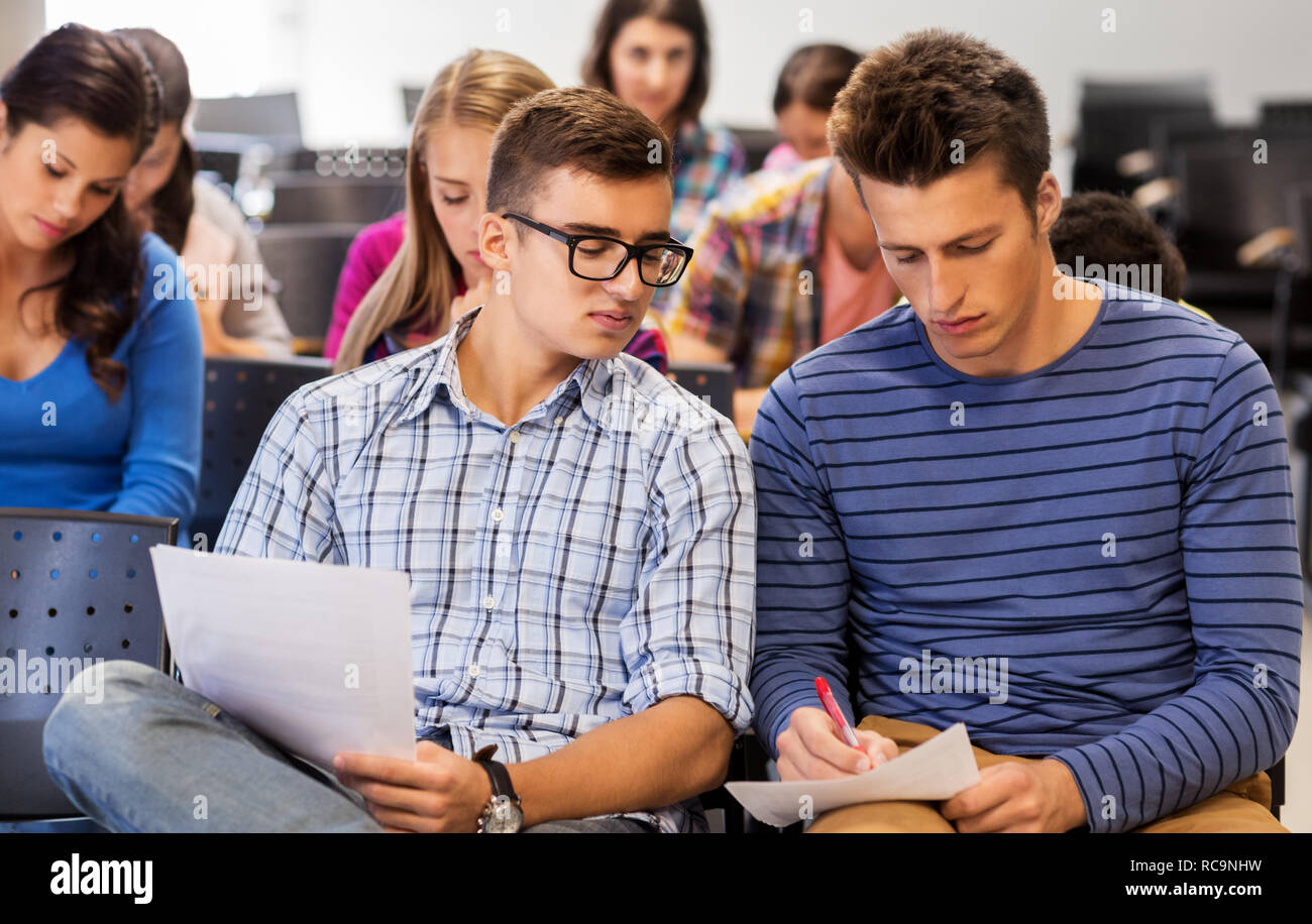 group of students with papers in lecture hall Stock Photo - Alamy