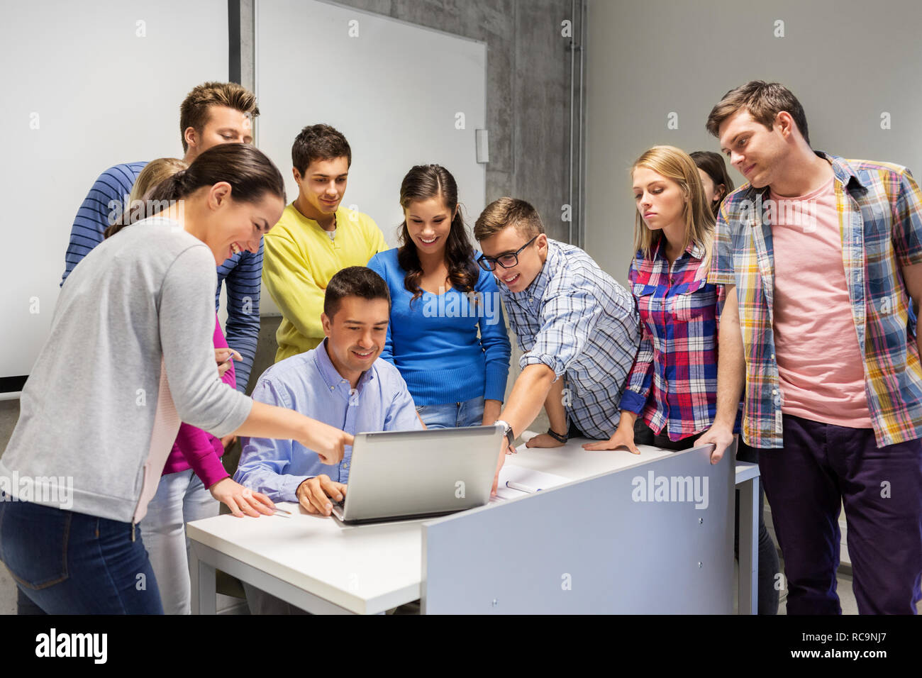 students and teacher with laptop at school Stock Photo - Alamy