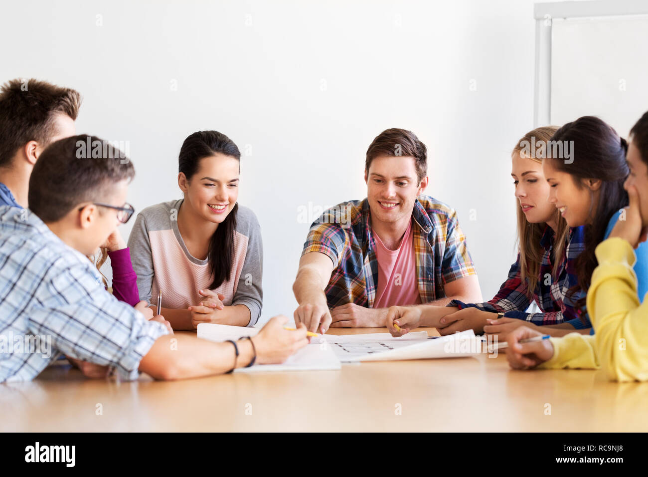 group of smiling students meeting at school Stock Photo - Alamy