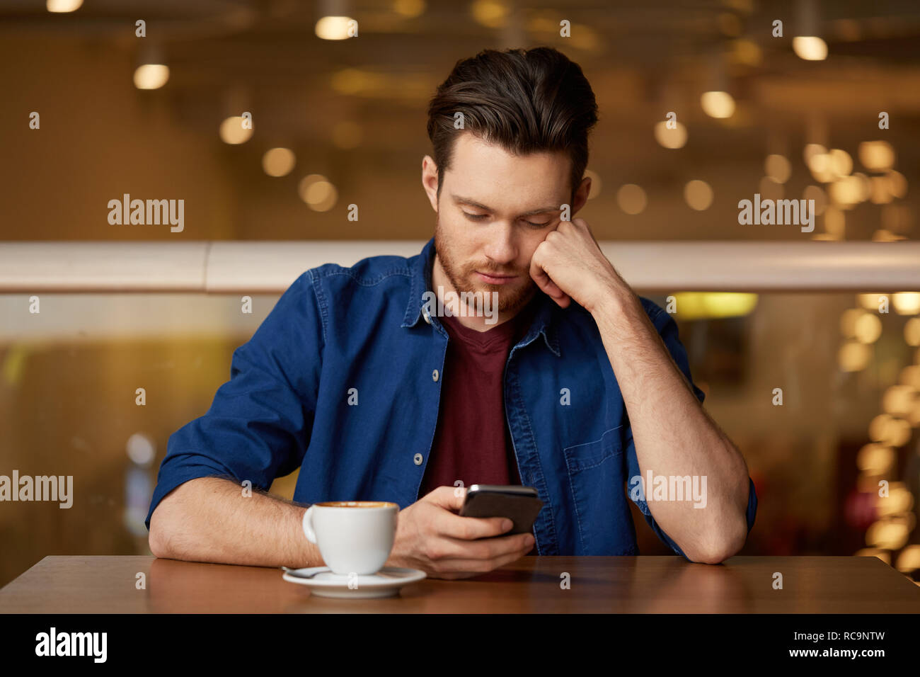 sad man with coffee and smartphone at restaurant Stock Photo - Alamy