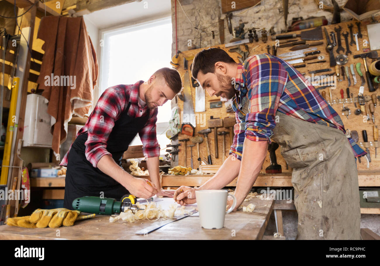 carpenters with ruler and blueprint at workshop Stock Photo - Alamy
