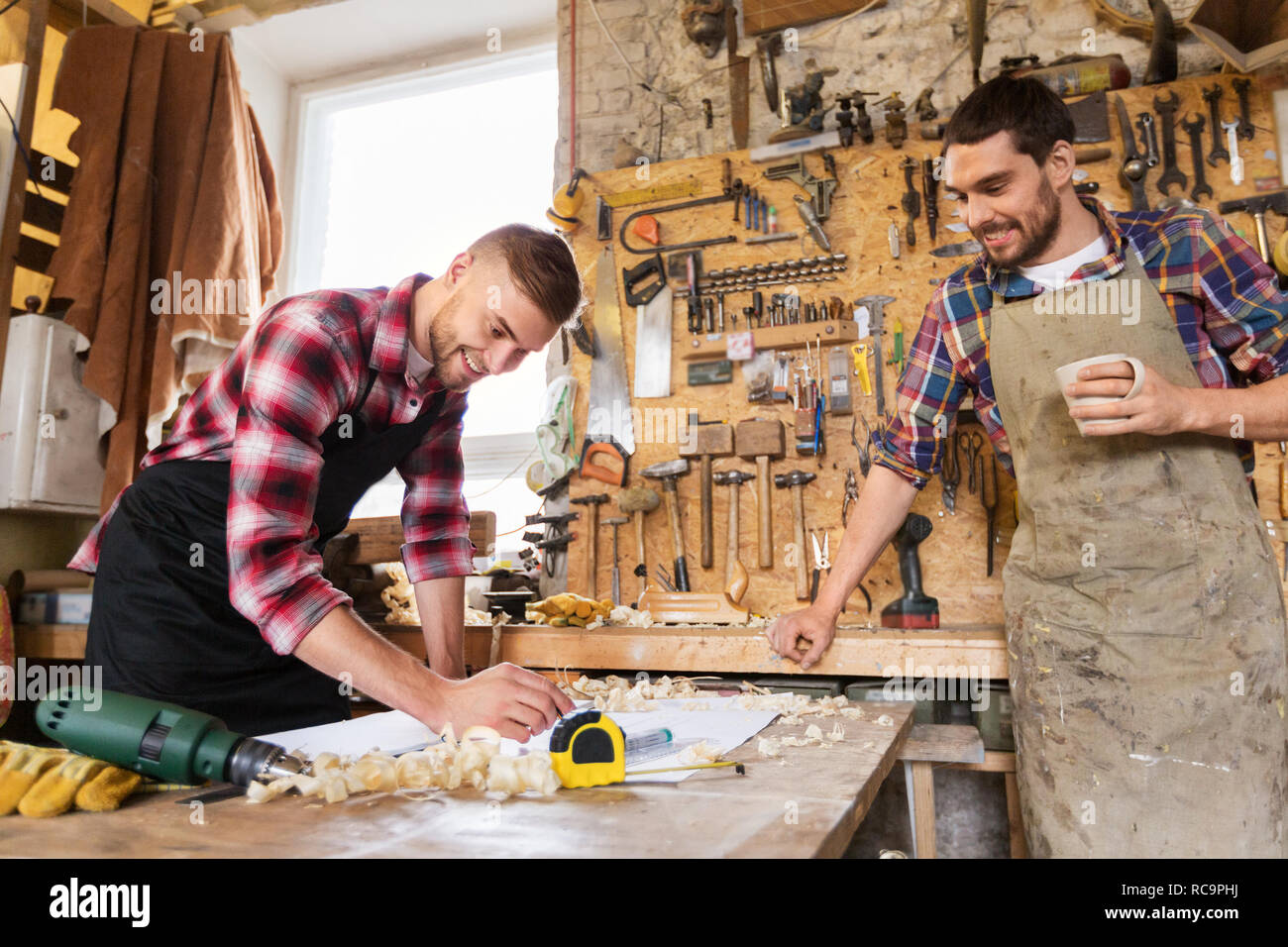 carpenters with ruler and coffee at workshop Stock Photo - Alamy