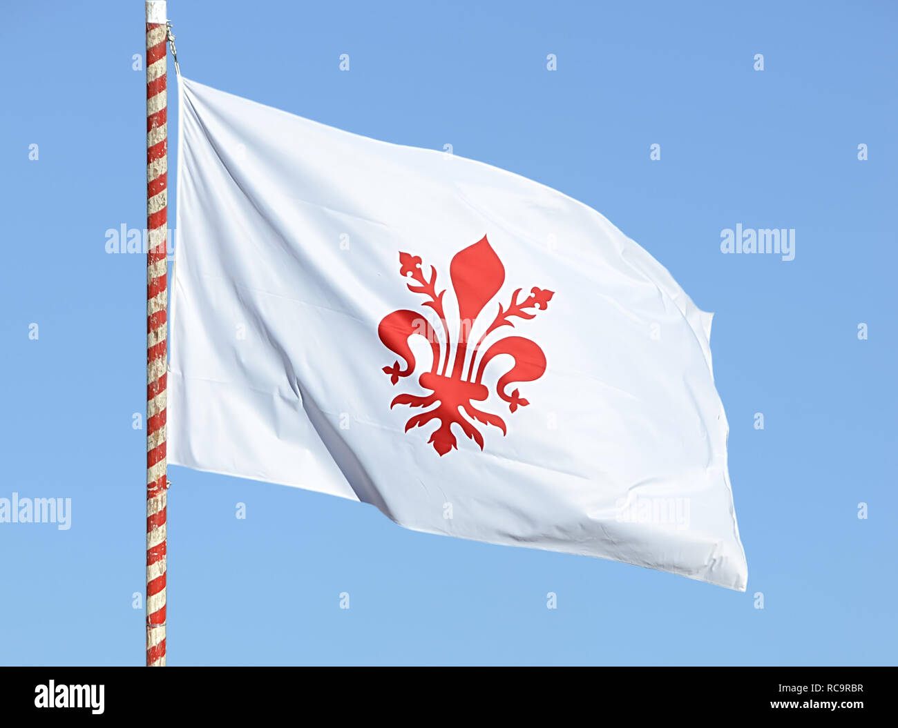 Flag of Florence with red lily waving in the sky Stock Photo - Alamy