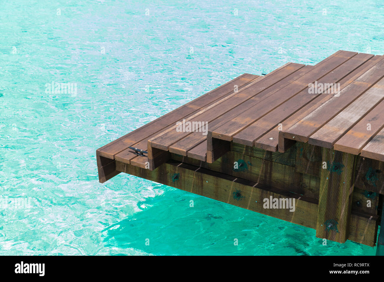 wooden pier with stair in sea water Stock Photo - Alamy