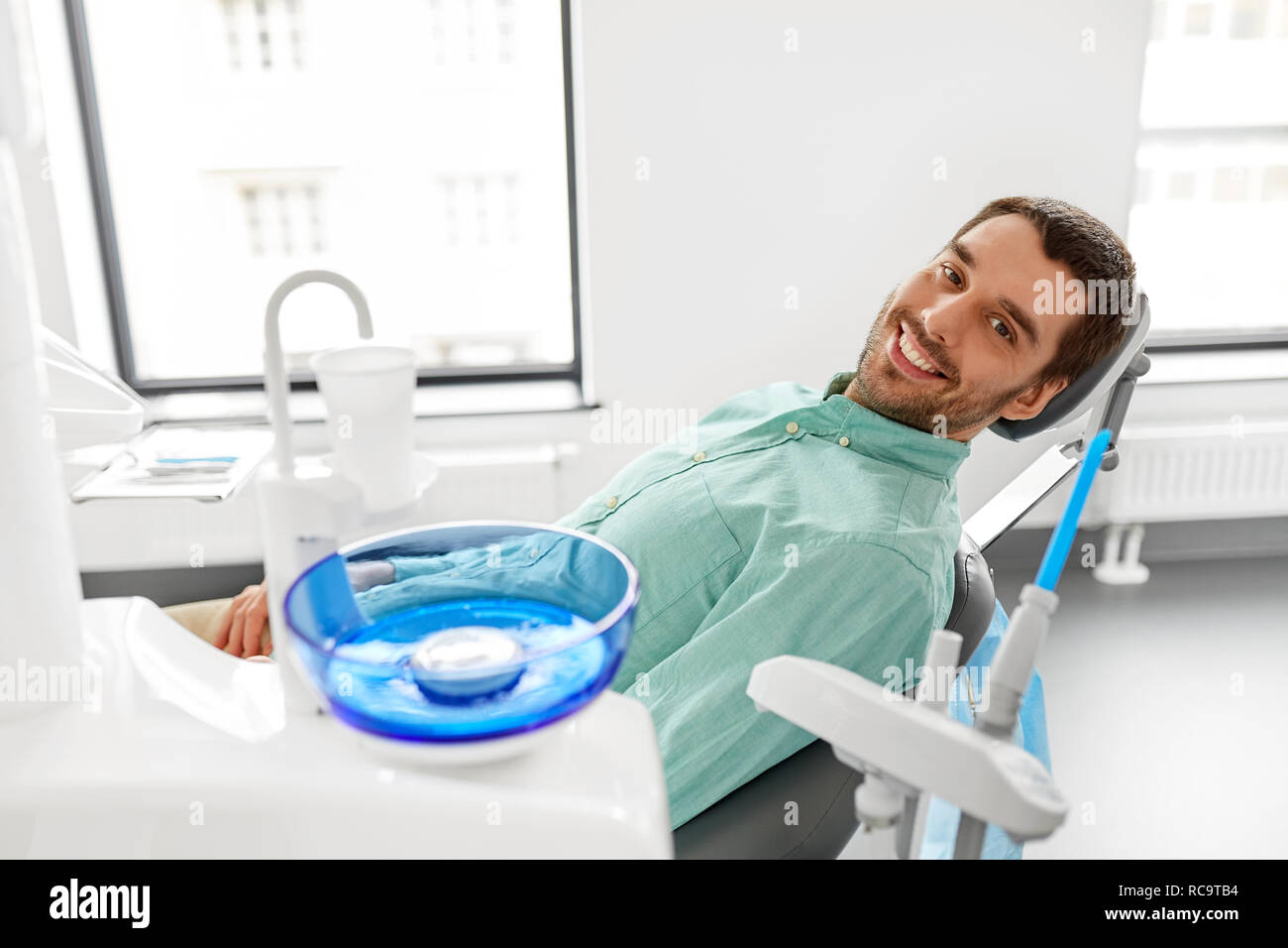 happy smiling male patient at dental clinic Stock Photo - Alamy