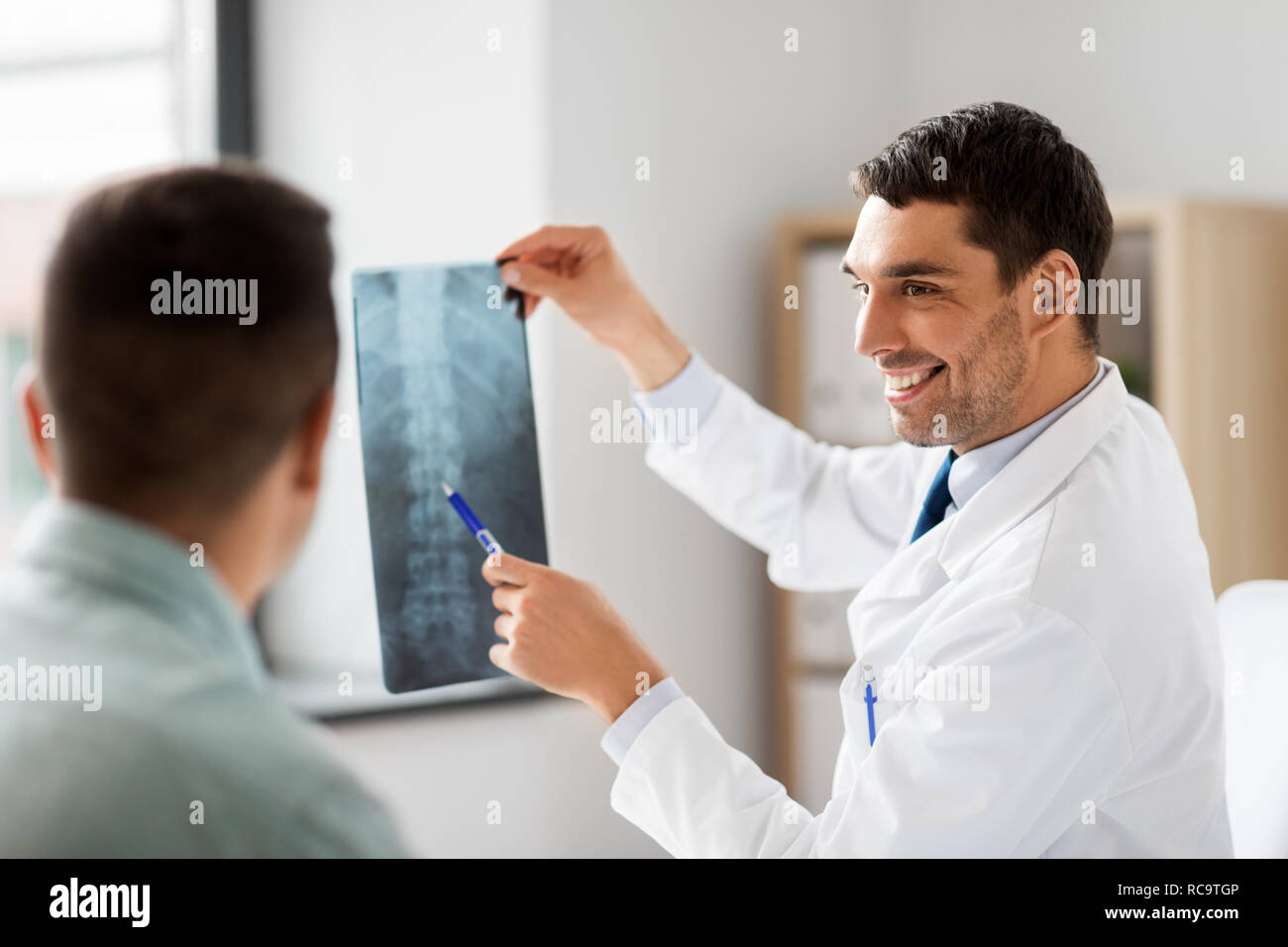 doctor showing x-ray to patient at hospital Stock Photo - Alamy