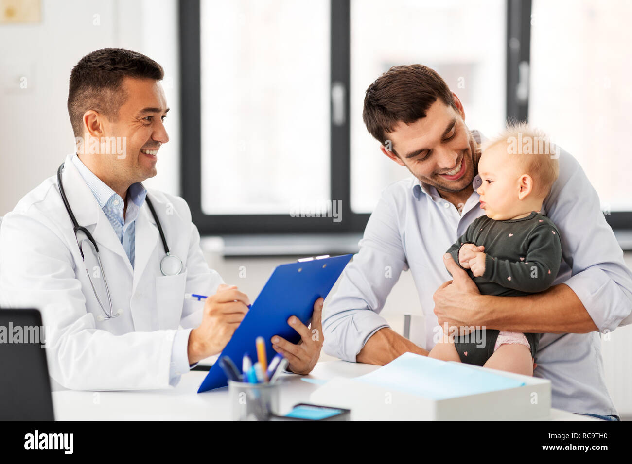 father with baby and doctor at clinic Stock Photo - Alamy