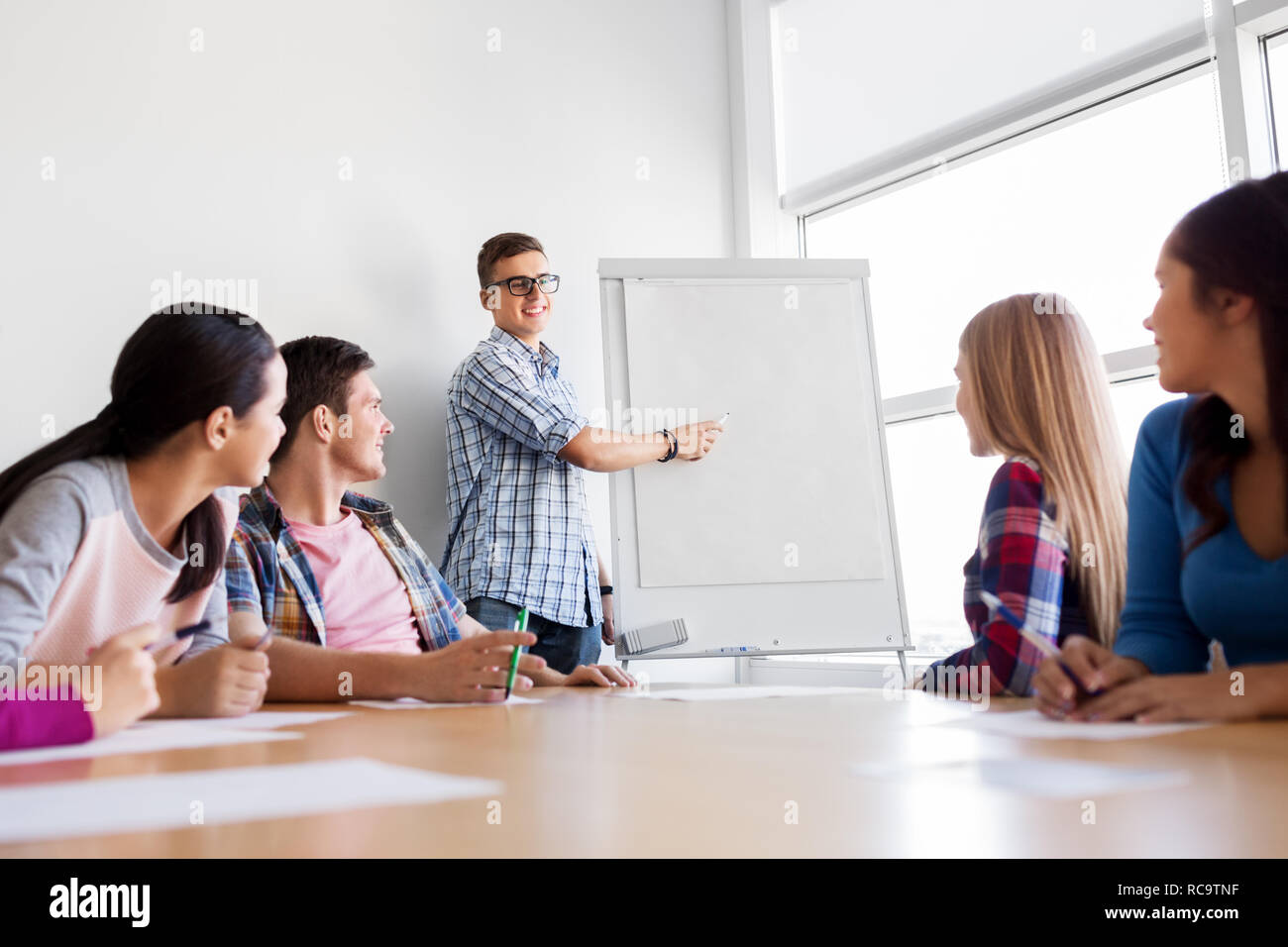group of high school students with flip chart Stock Photo - Alamy