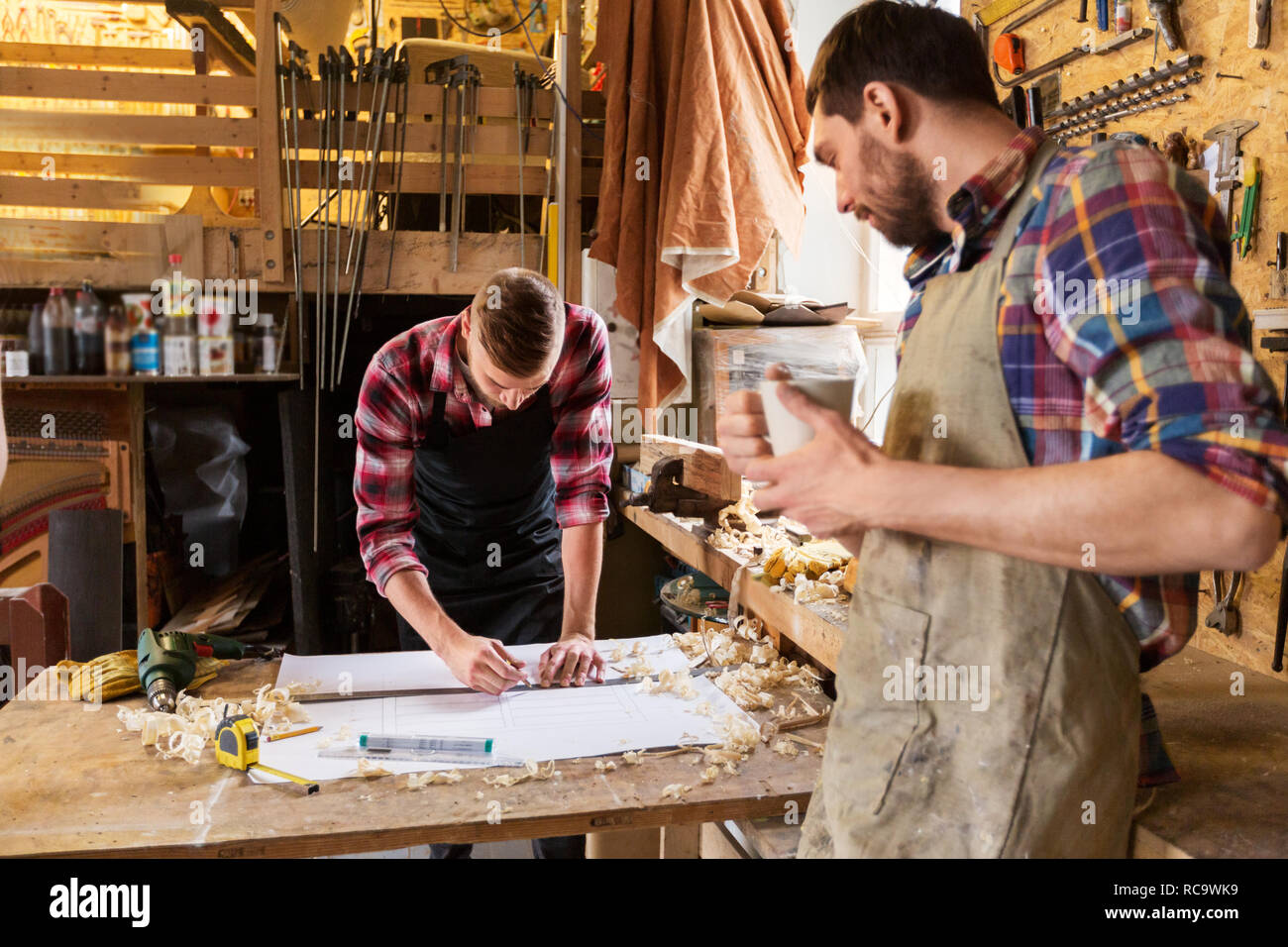 carpenters with ruler and blueprint at workshop Stock Photo - Alamy