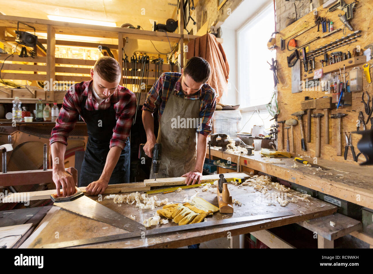 carpenters working with wooden board at workshop Stock Photo - Alamy