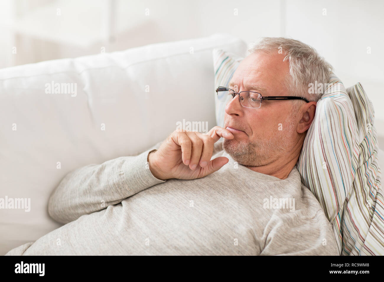 Thinking pensive man lying on hi-res stock photography and images - Alamy