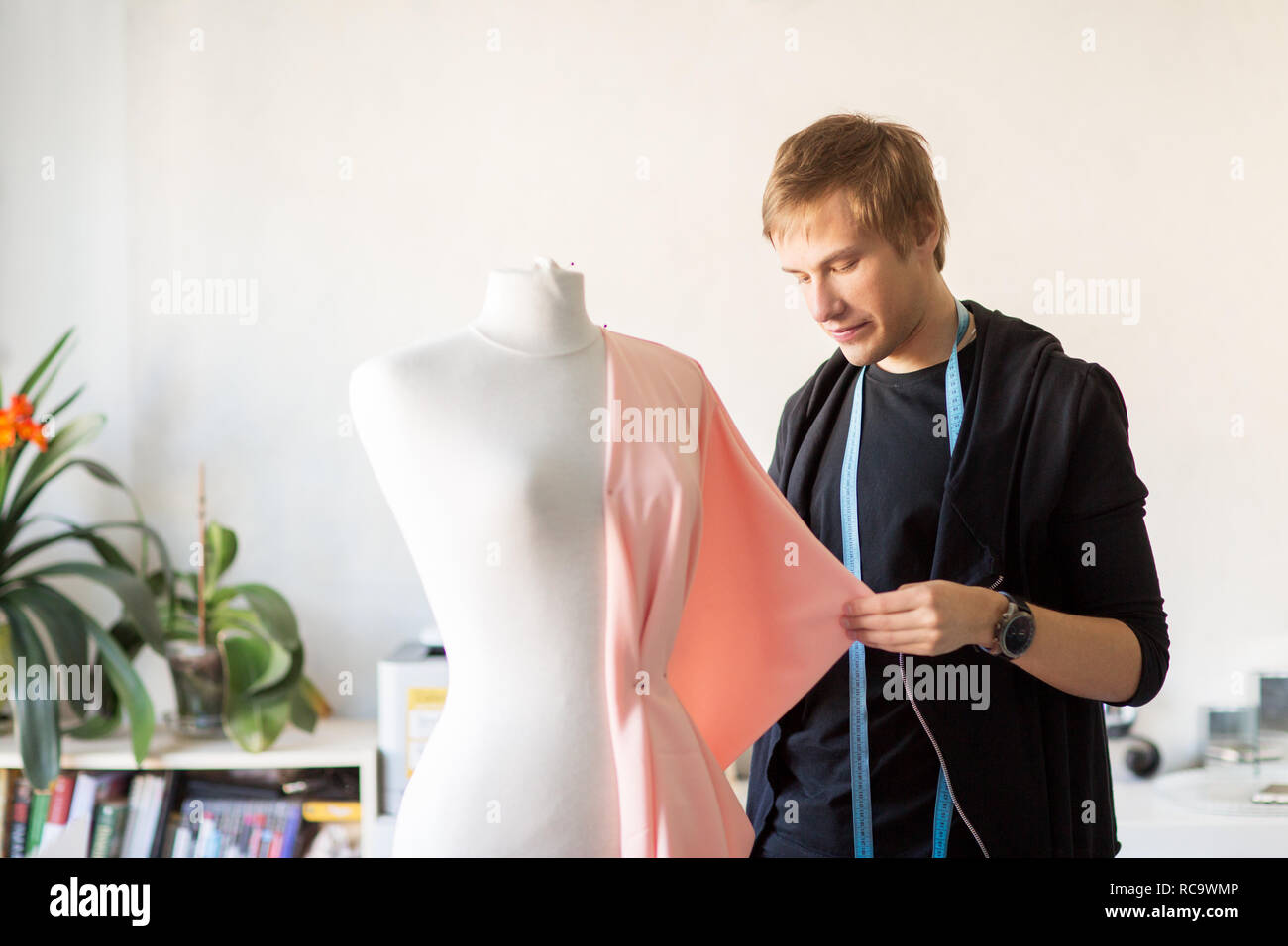 fashion designer with dummy making dress at studio Stock Photo - Alamy
